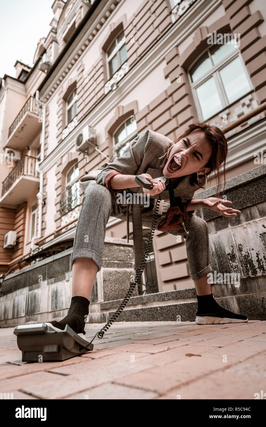 Aggressive emotions. Red-haired fashionable photo model showing ...