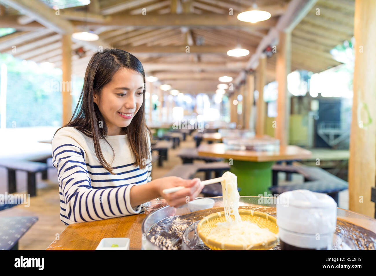 Woman eating cold somen in japanese restaurant Stock Photo - Alamy