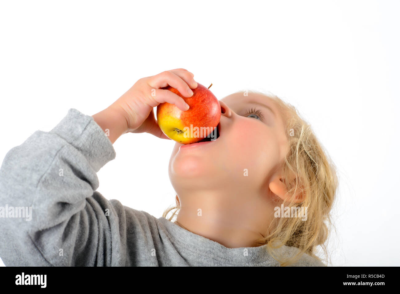 funny girl eating apple Stock Photo - Alamy