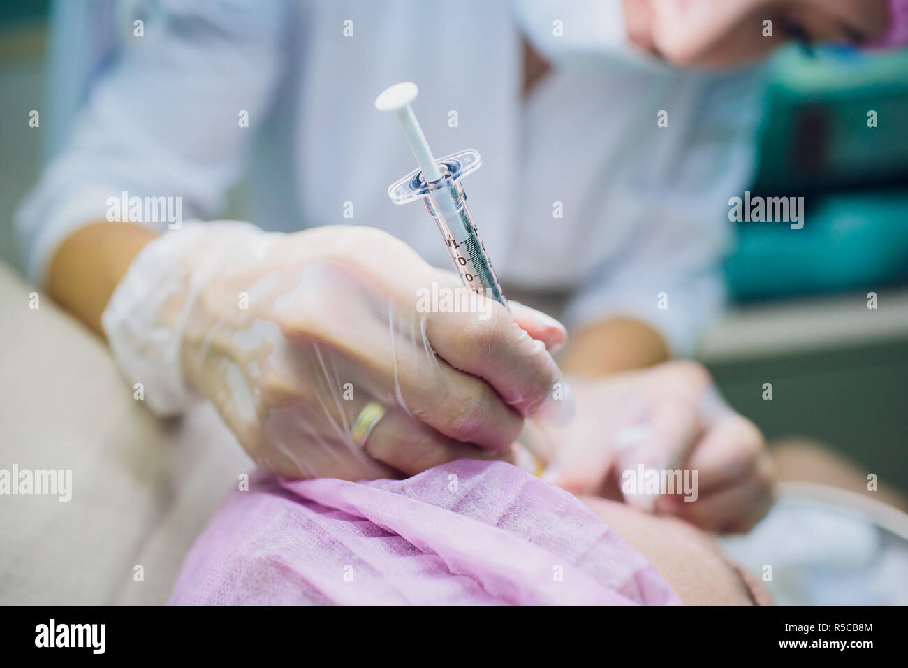 The doctor cosmetologist makes the Rejuvenating facial injections ...