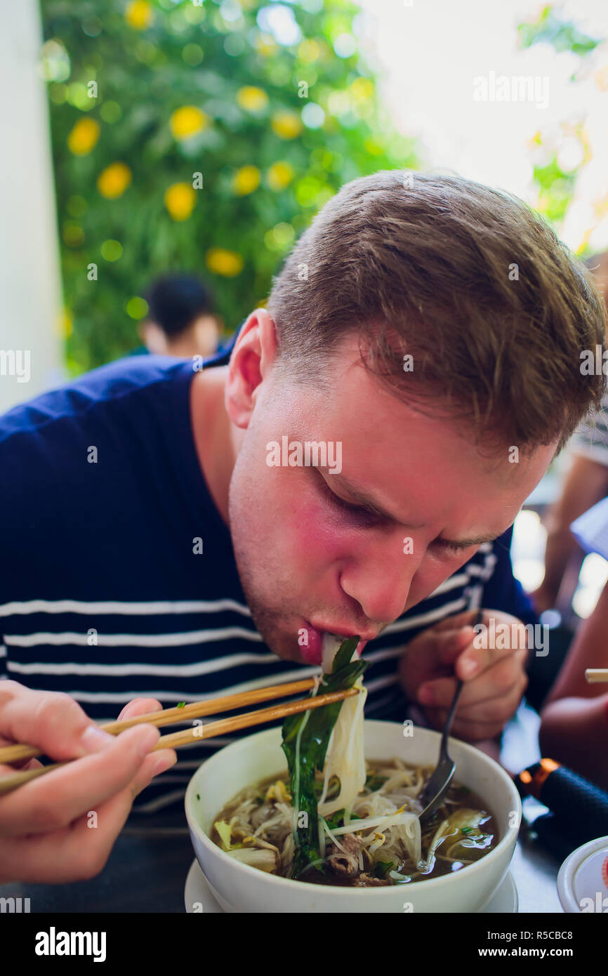 Man eating noodle soup in hi-res stock photography and images - Alamy