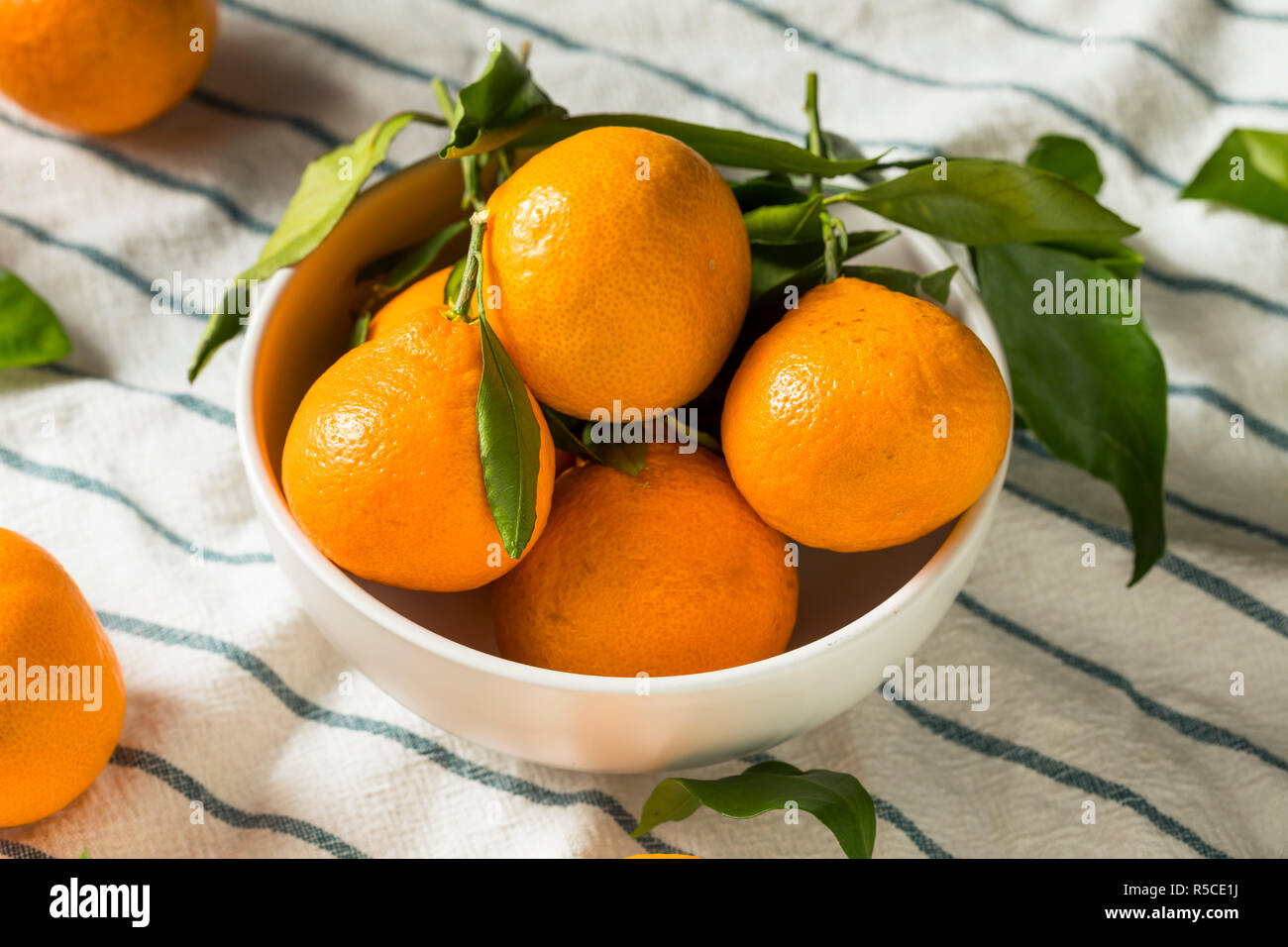Raw Organic Mandarin Oranges with Green Leaves Stock Photo - Alamy