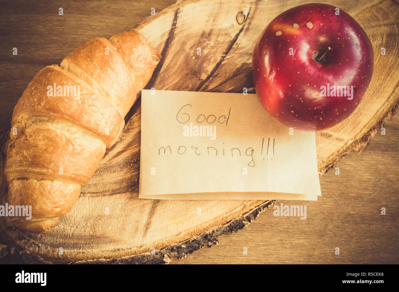 Apple, Croissant and Good Morning Note on Rustic Wooden Background ...