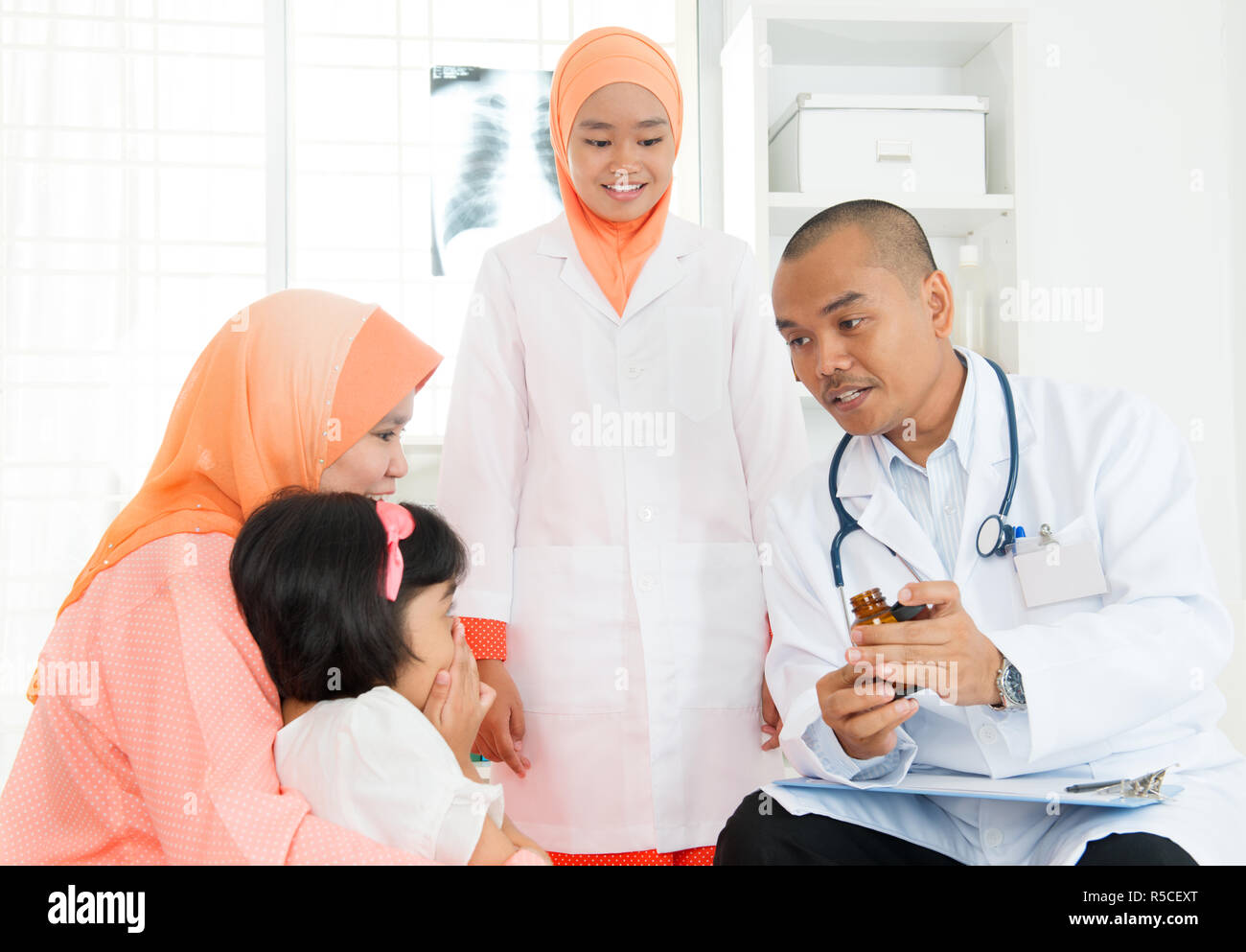 Muslim family consulting doctor Stock Photo - Alamy