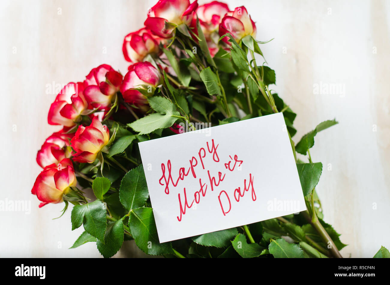 Bouquet of red roses and greeting card with text Happy Mothers Day ...