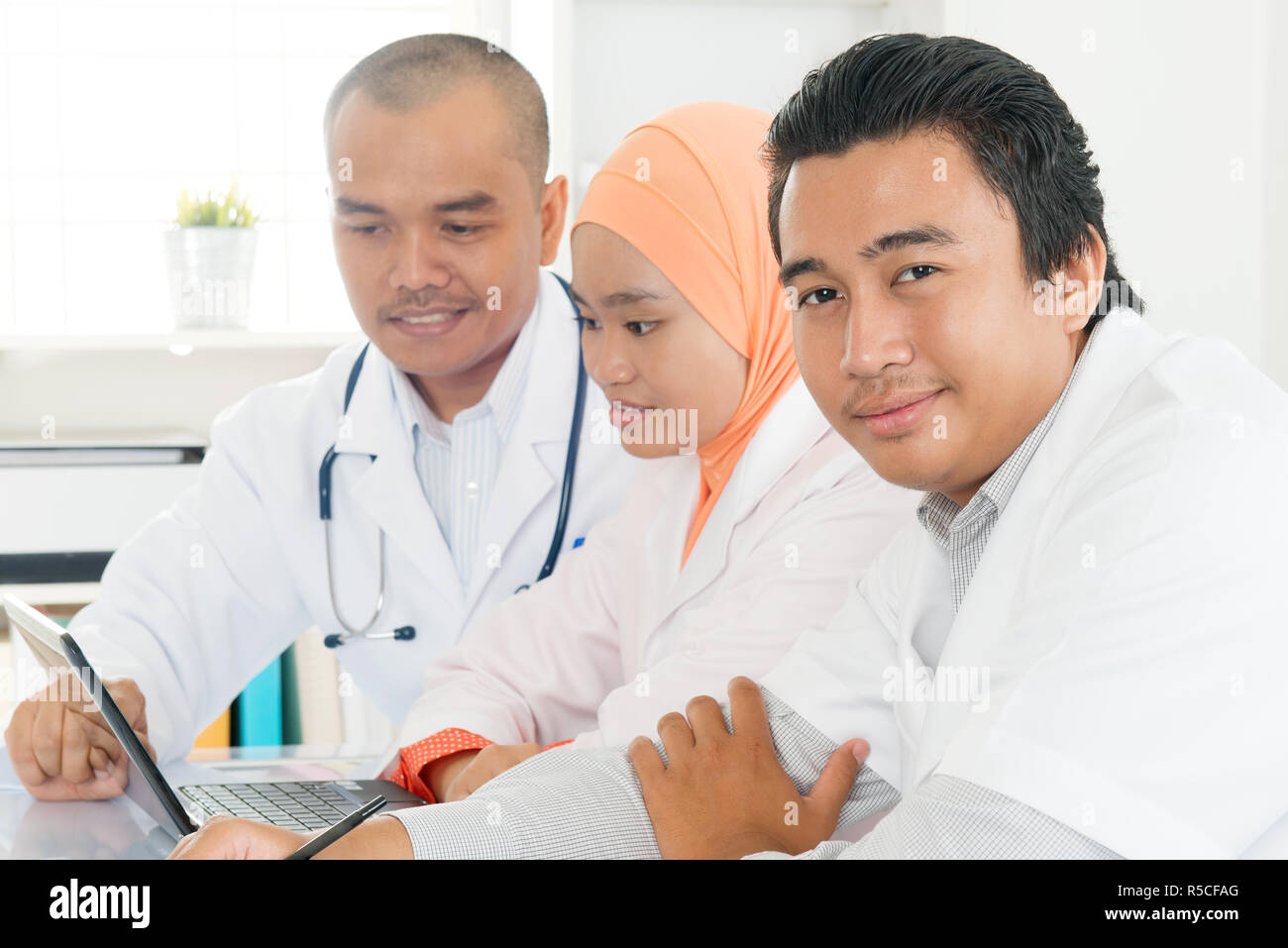 Doctors discussing at hospital office Stock Photo - Alamy