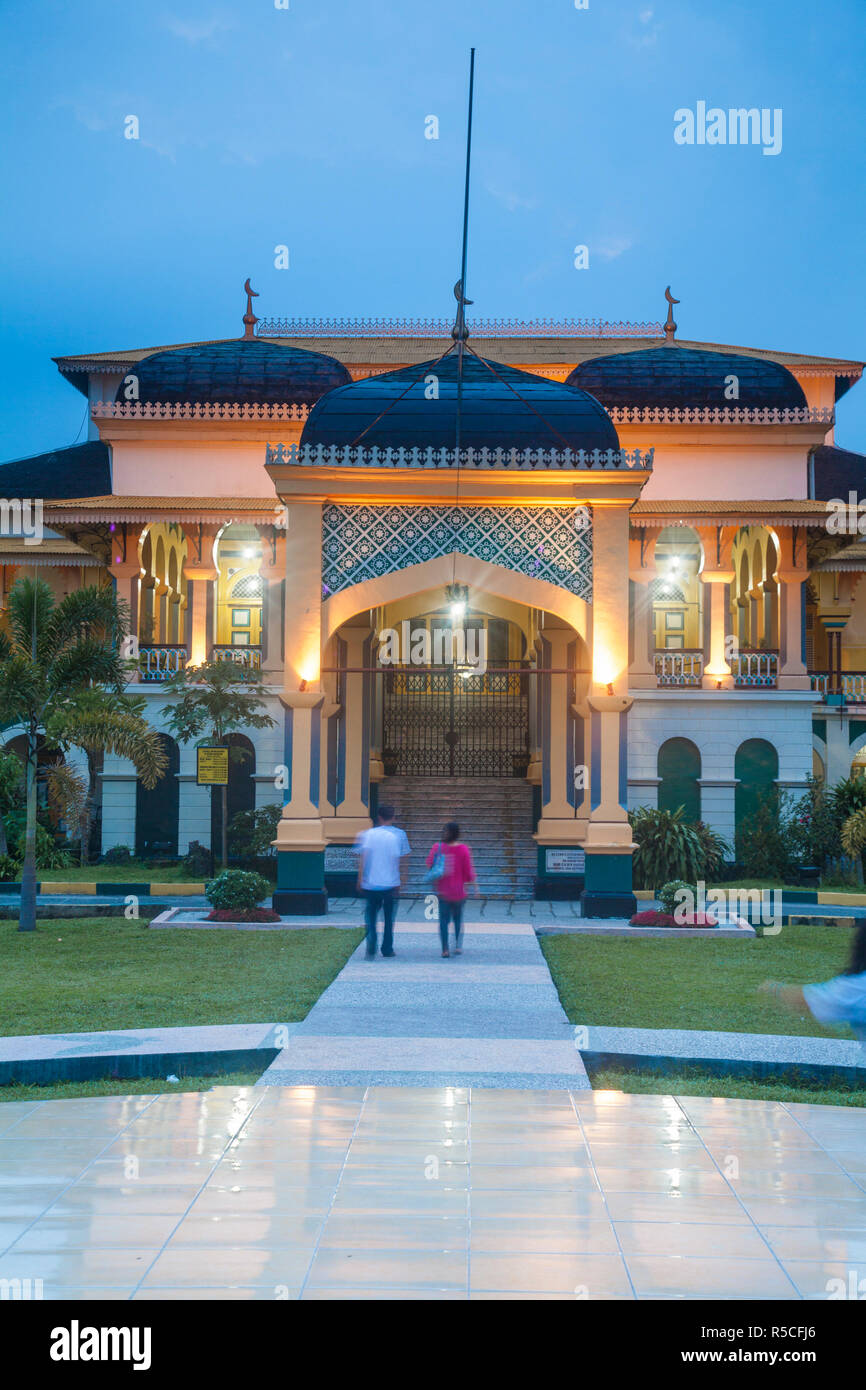 Indonesia, Sumatra, Medan, Couple walk towards Maimoon Palace Stock ...