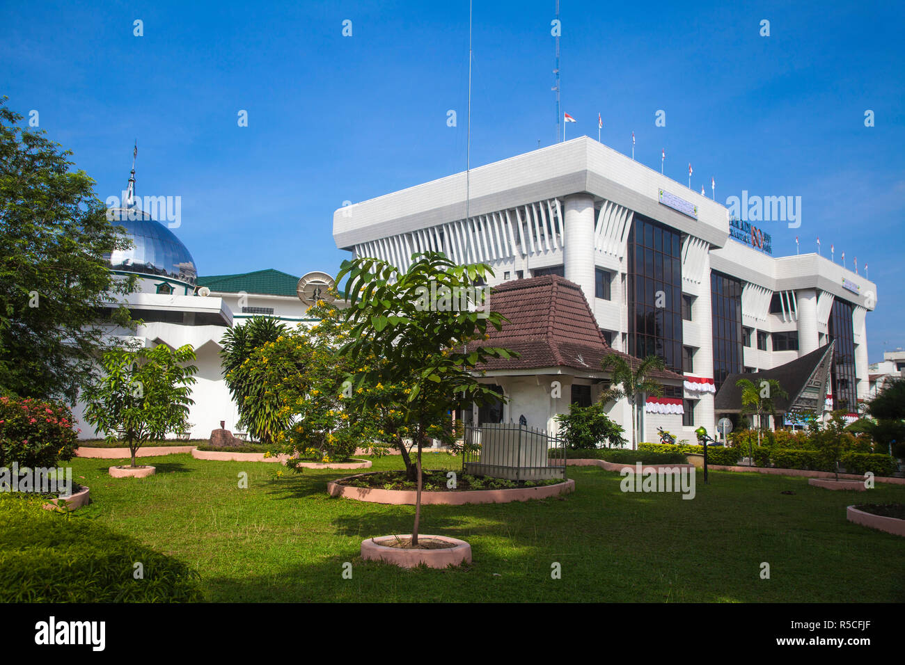Indonesia, Sumatra, Medan, Mosque and Building next to Water Tower ...