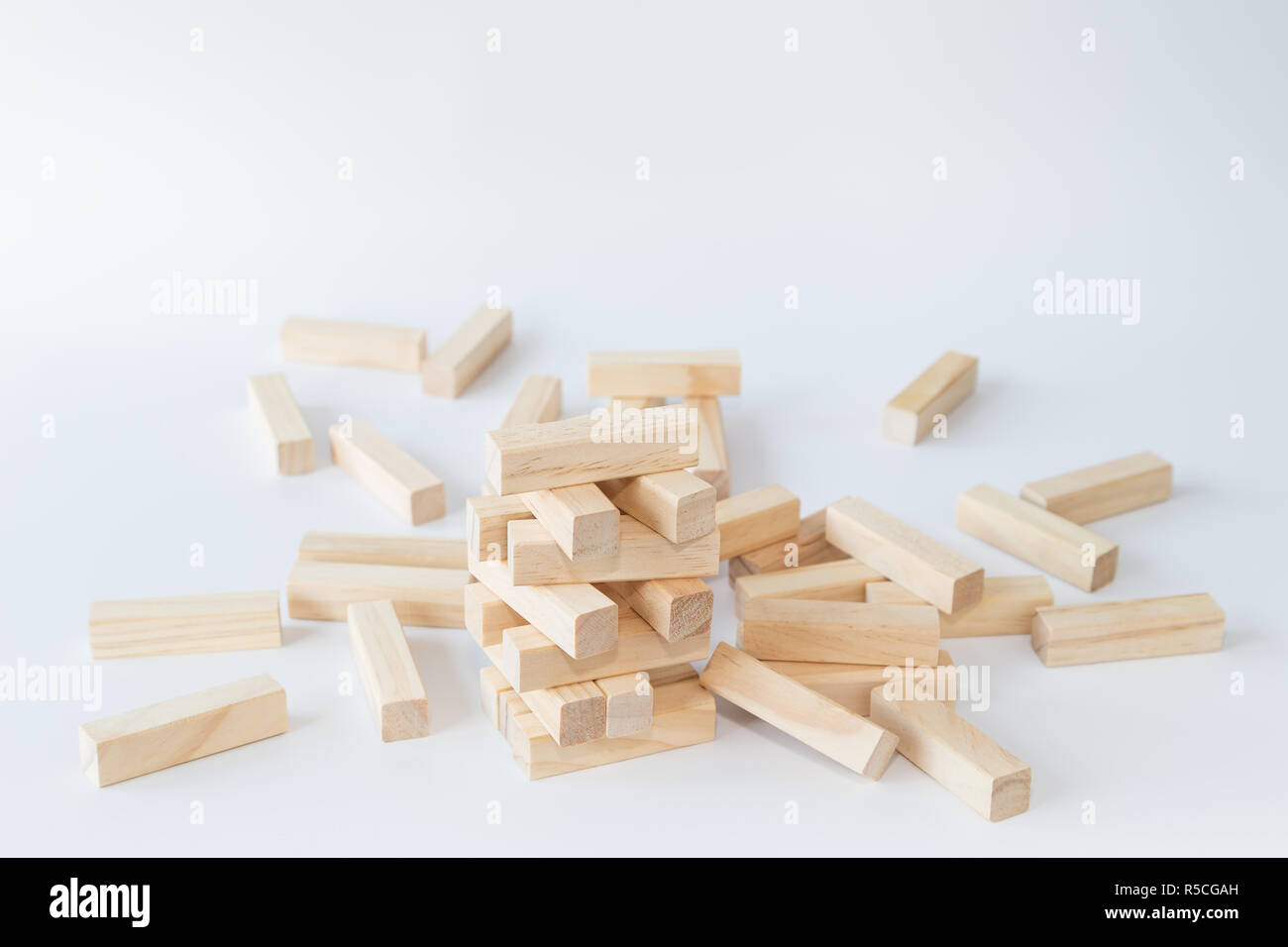 Pile and scattered wooden blocks on a light gray background. Copy space ...