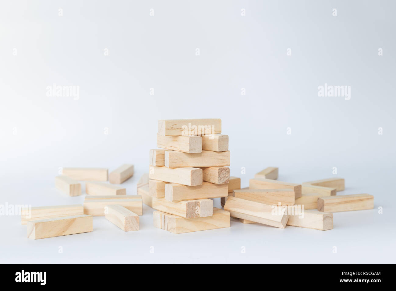 Pile and scattered wooden blocks on a light gray background. Copy space ...