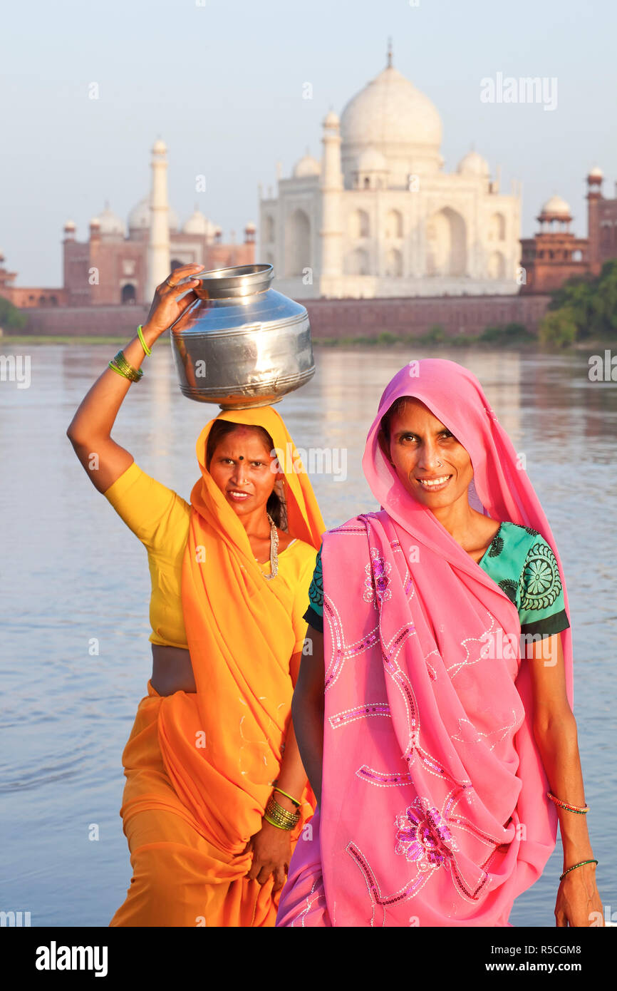 Taj Mahal across the Yamuna River, Women in colourful Saris collecting ...