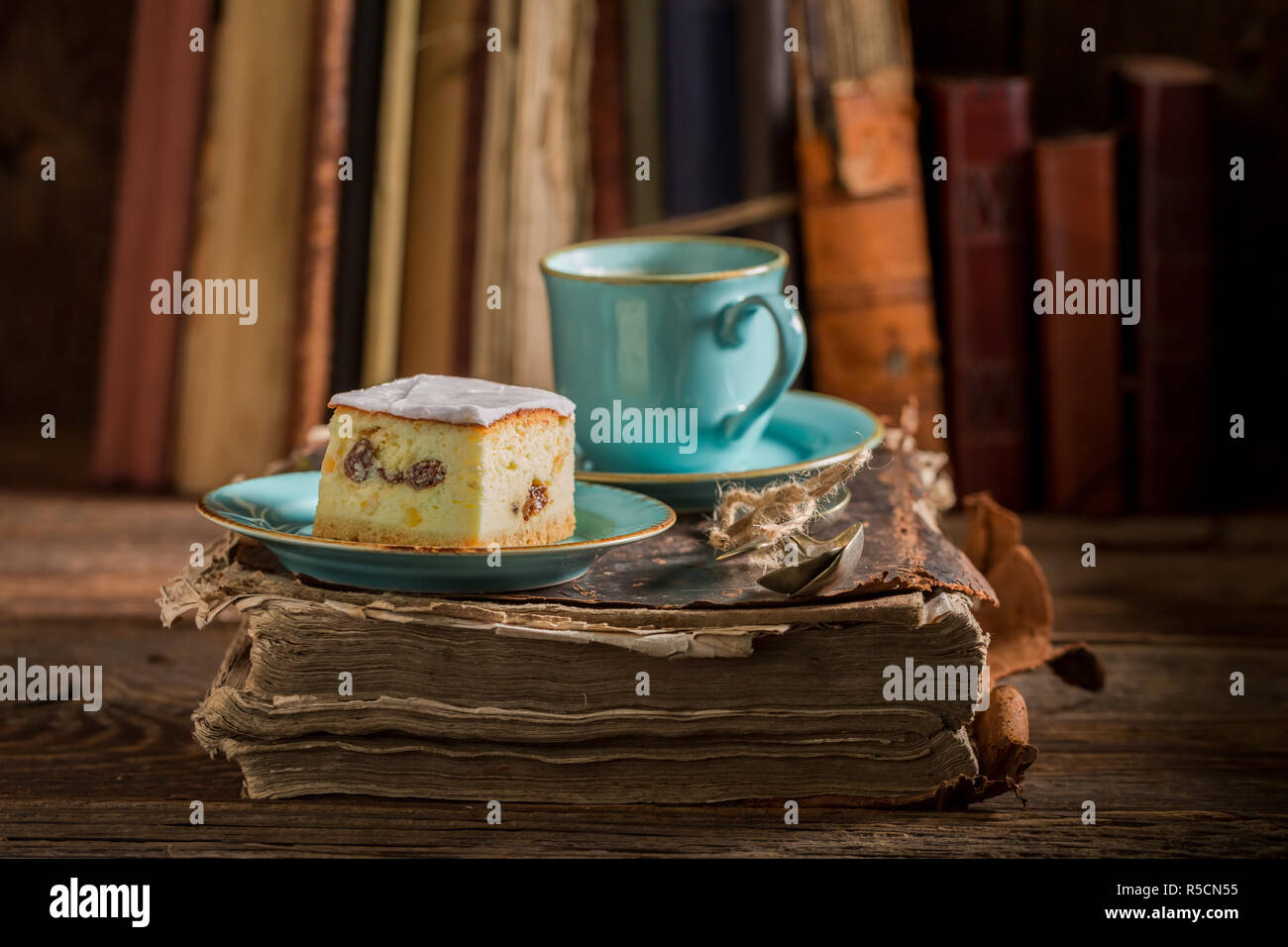 Homemade cheesecake and coffee on old book in library Stock Photo - Alamy