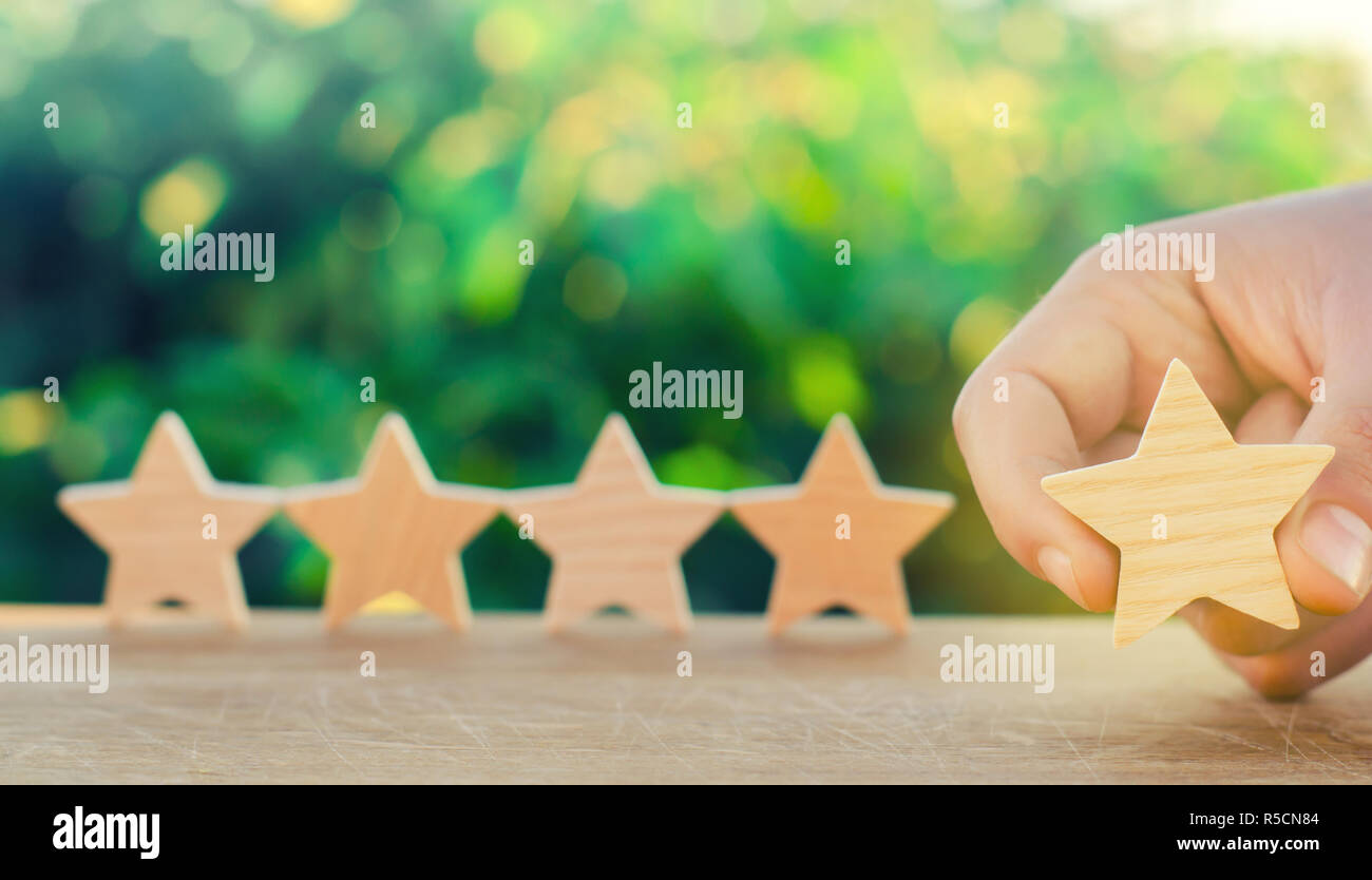 Five wooden stars. Get the fifth star. The concept of the rating of ...