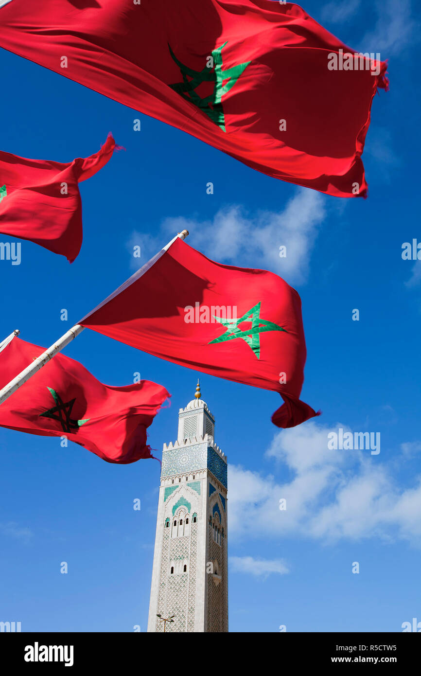 Flags of Morocco waving in the wind and Hassan II Mosque, the third ...