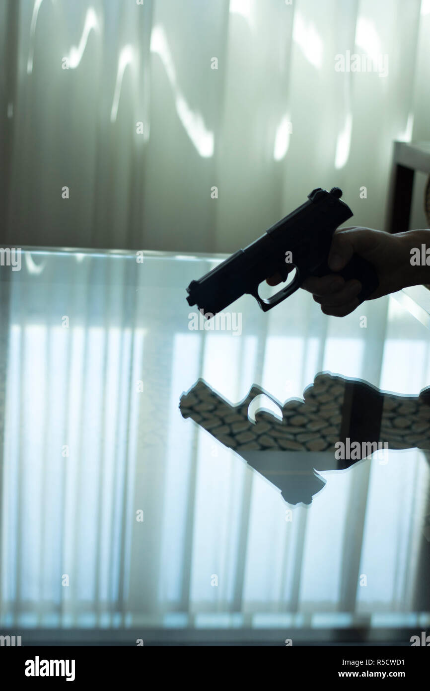 Automatic pistol gun on glass table in bedroom in luxury hotel in ...