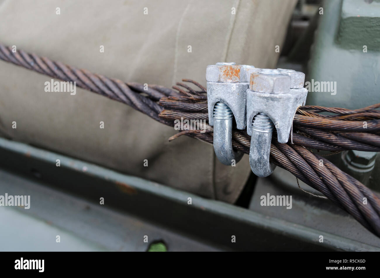 Detail of securing brackets on rusty steel cable Stock Photo - Alamy