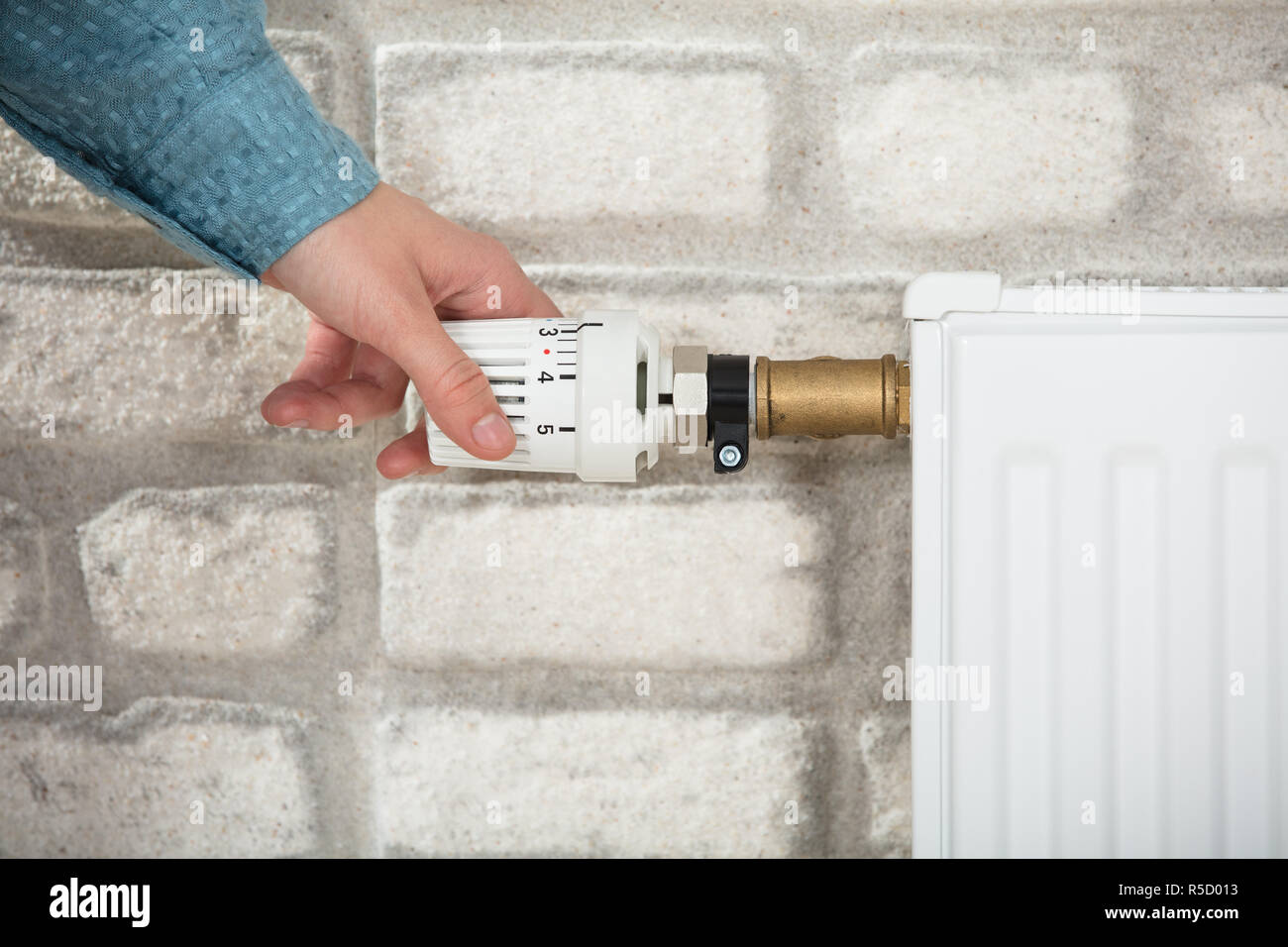 Person Adjusting Temperature Of Radiator Stock Photo - Alamy