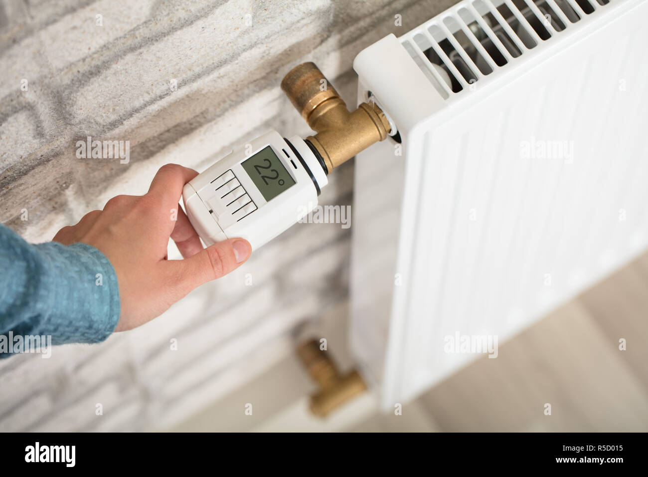 Person Adjusting Temperature On Thermostat Stock Photo - Alamy