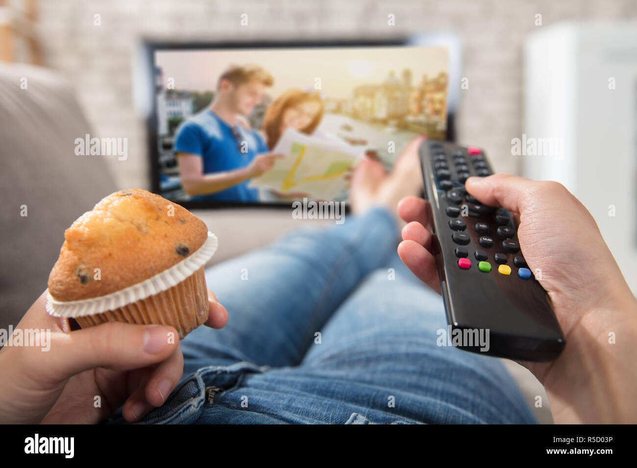 Woman Holding Cupcake And Remote Control In Hand Stock Photo - Alamy