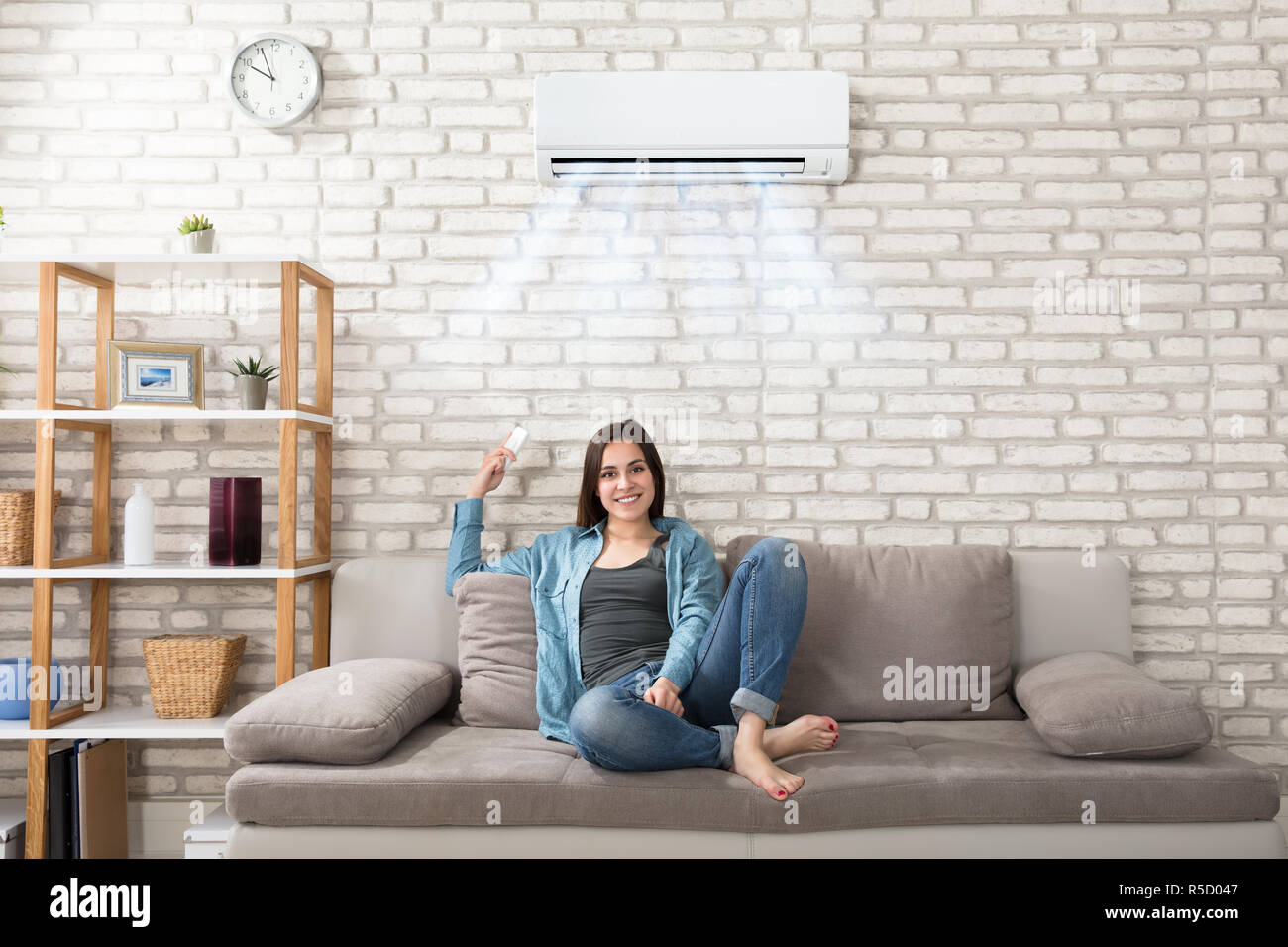 Woman Relaxing Under The Air Conditioner Stock Photo - Alamy