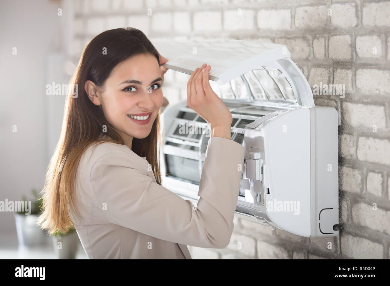 Woman Opening Air Conditioner Stock Photo - Alamy