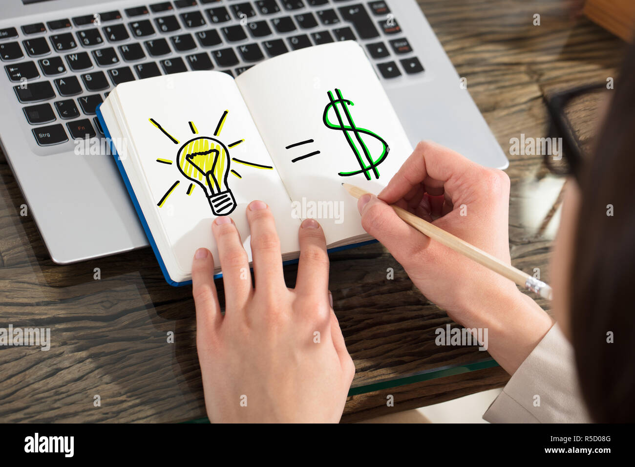 Light Bulb And The Financial Gain Drawing On Notebook Stock Photo - Alamy