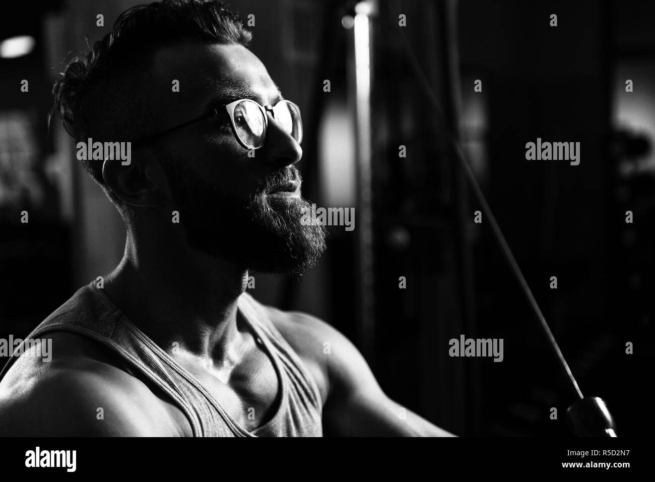 Muscular Man Doing Heavy Weight Exercise For Chest On Machine With ...