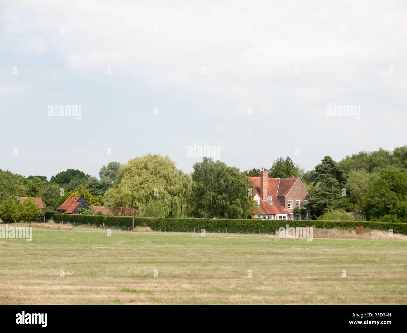 A Farm House in the Distance Across a Field Stock Photo - Alamy