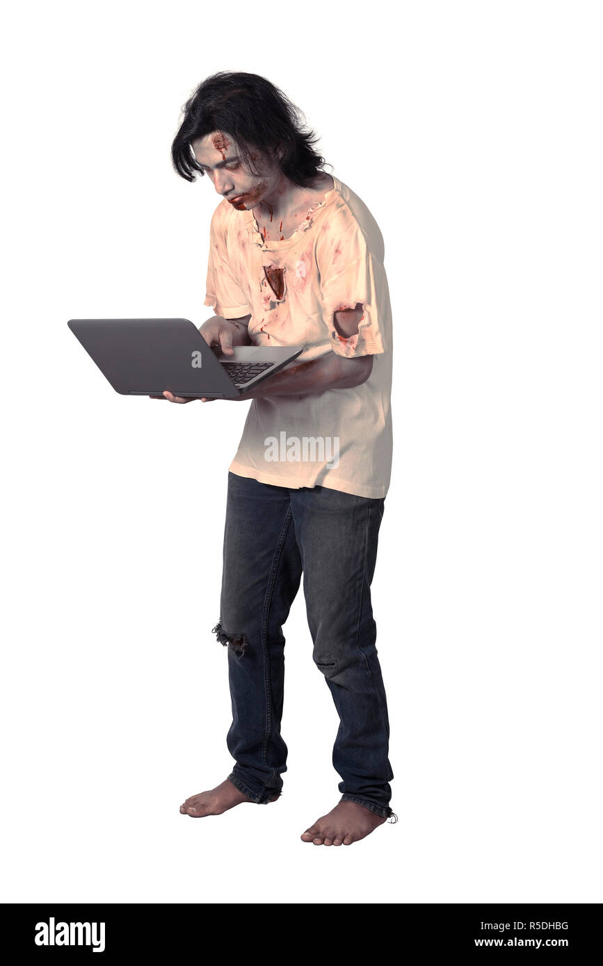 Creepy asian male zombie typing with laptop Stock Photo - Alamy