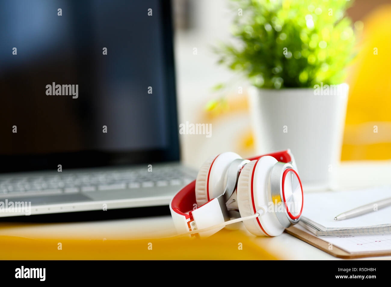 Empty remote office workplace with laptop and headset Stock Photo - Alamy