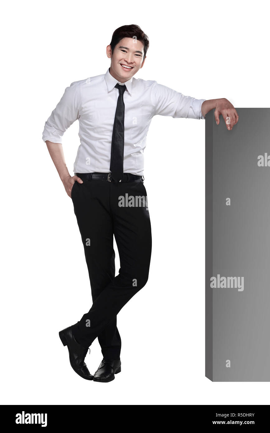 Asian business man lean on the block Stock Photo - Alamy