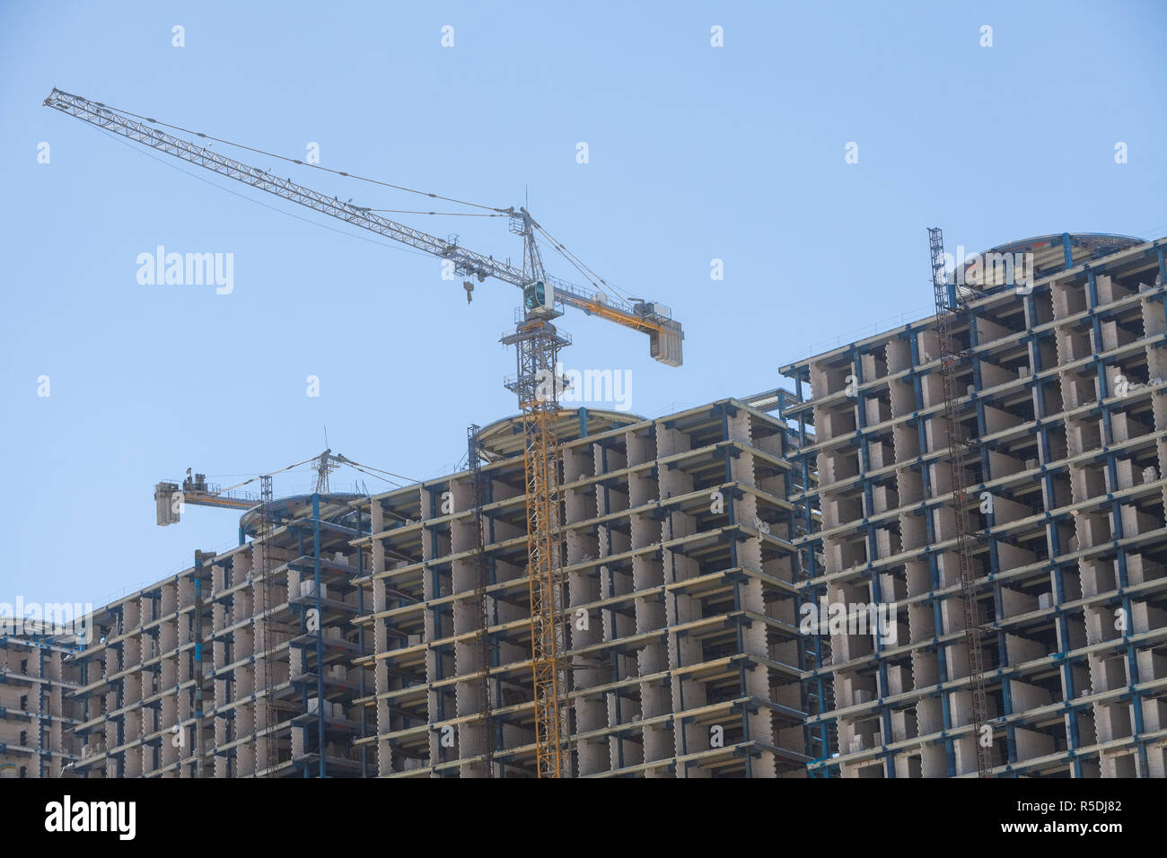 Cranes building a block Stock Photo - Alamy