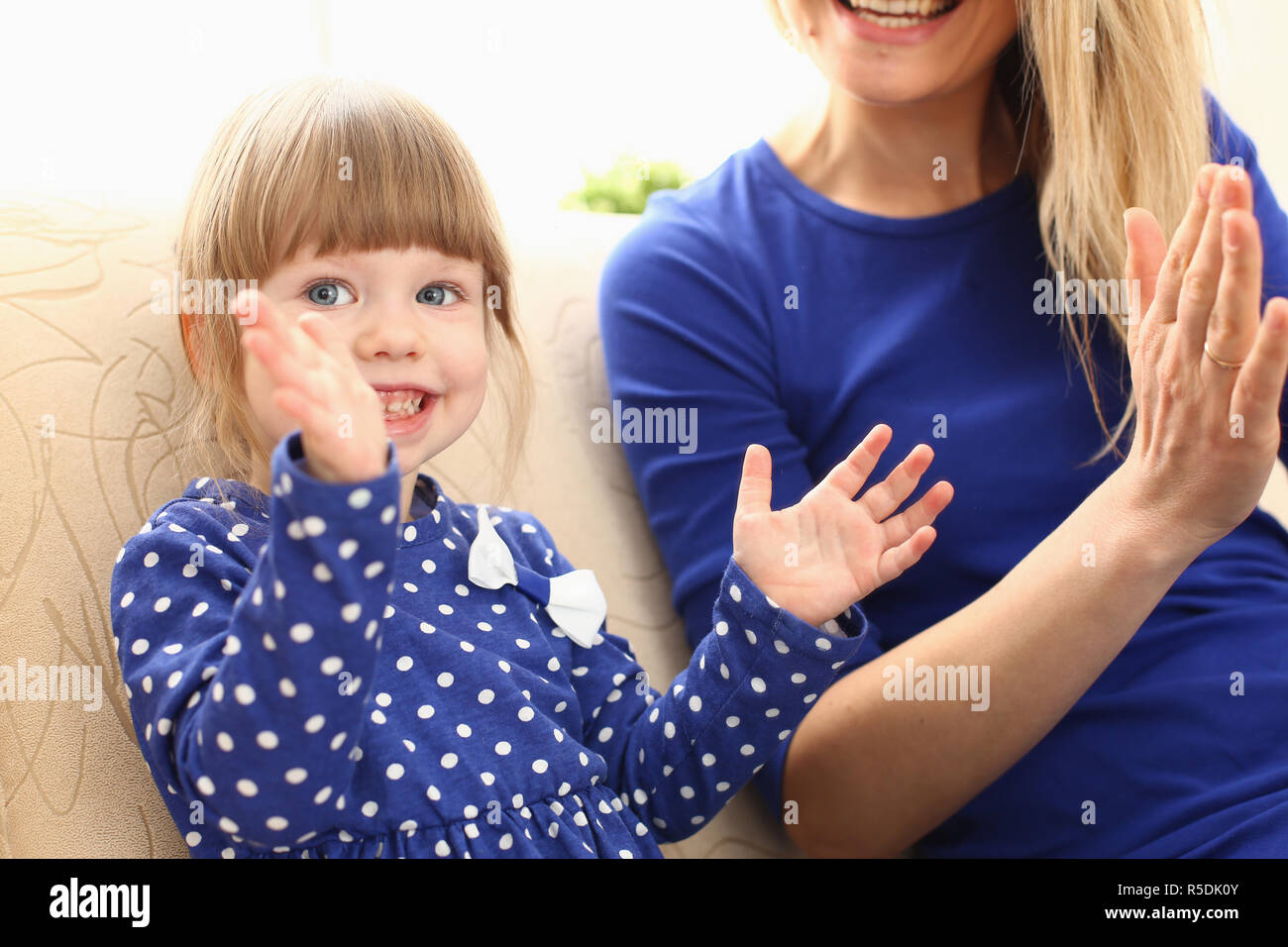 Cute little girl play with mom pat-a-cake Stock Photo - Alamy