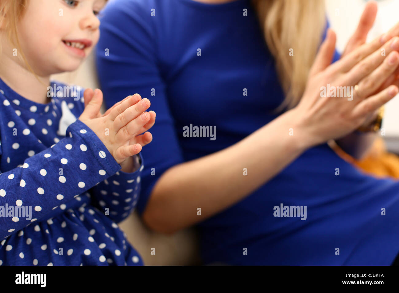 Cute little girl play with mom pat-a-cake Stock Photo - Alamy