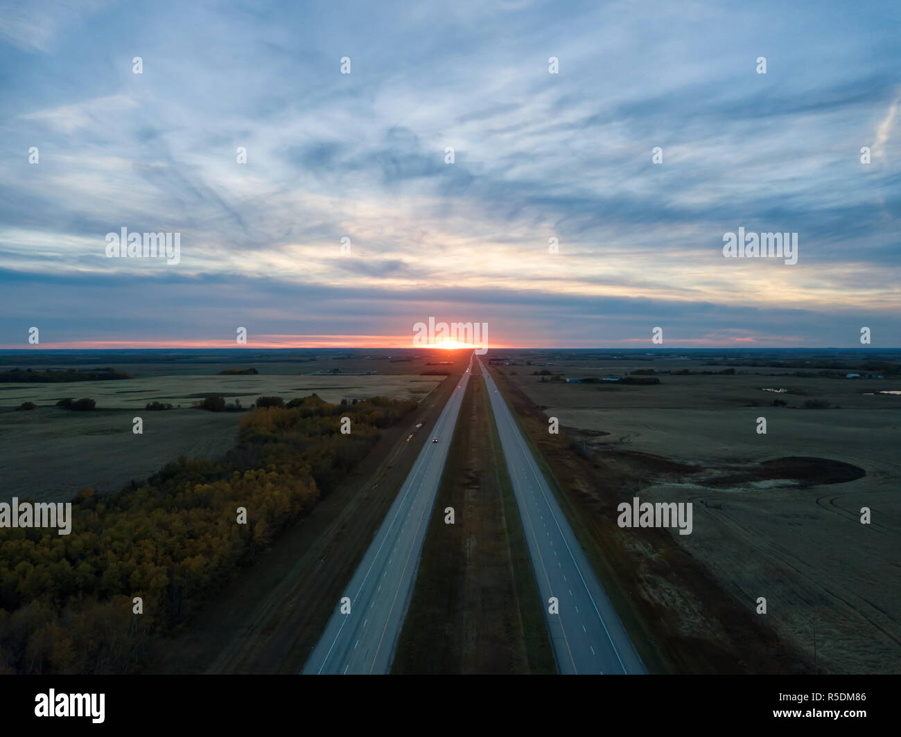 Aerial view of the Highway in the Prairies during a vibrant cloudy ...