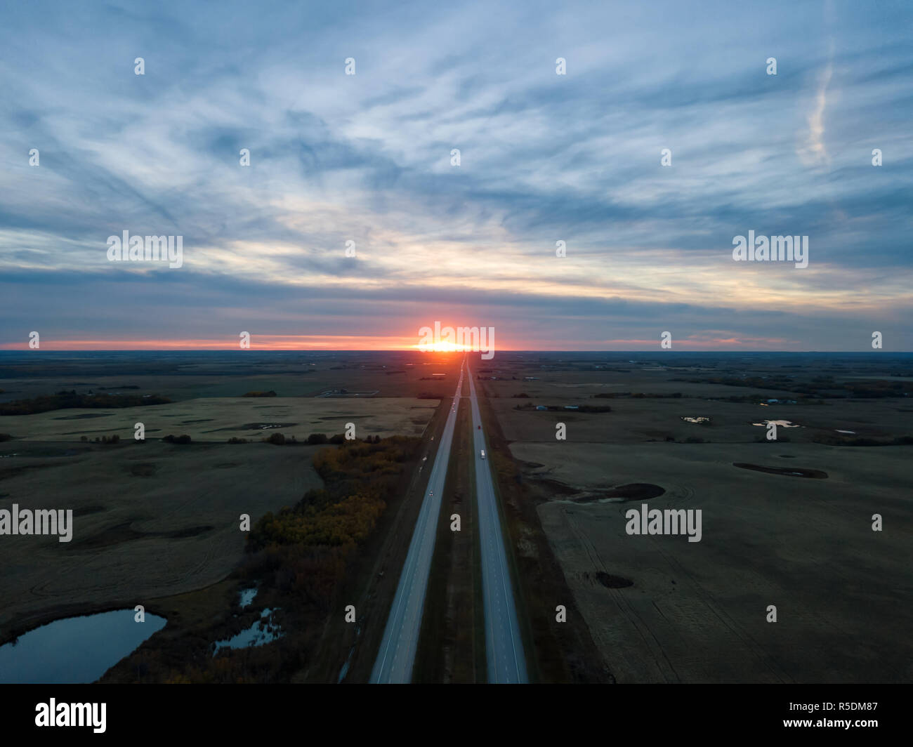 Aerial view of the Highway in the Prairies during a vibrant cloudy ...