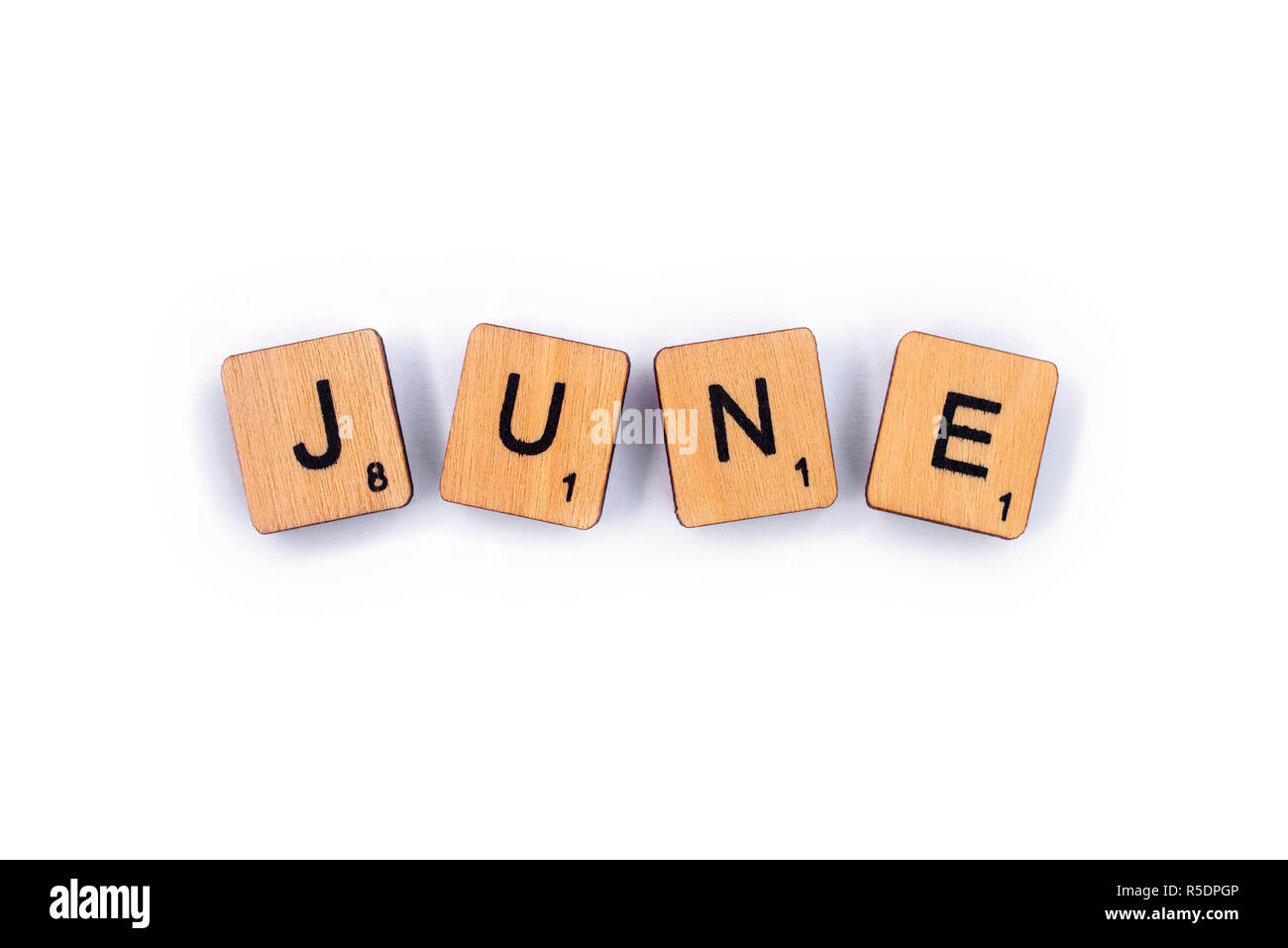London, UK - July 8th 2018: JUNE, spelt with wooden letter tiles over a ...