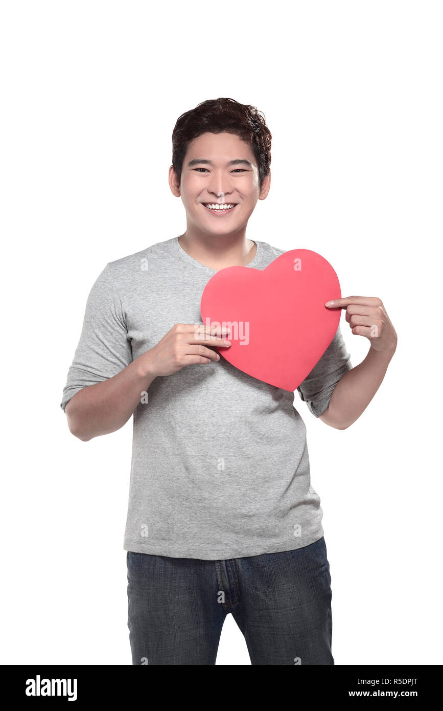 Asian man holding red heart Stock Photo - Alamy