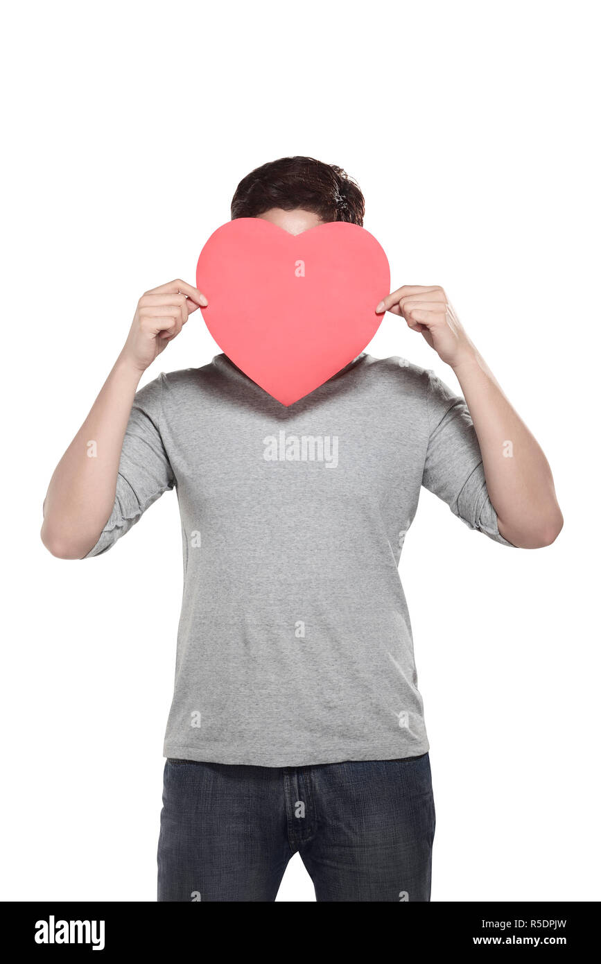 Asian man holding red heart Stock Photo - Alamy