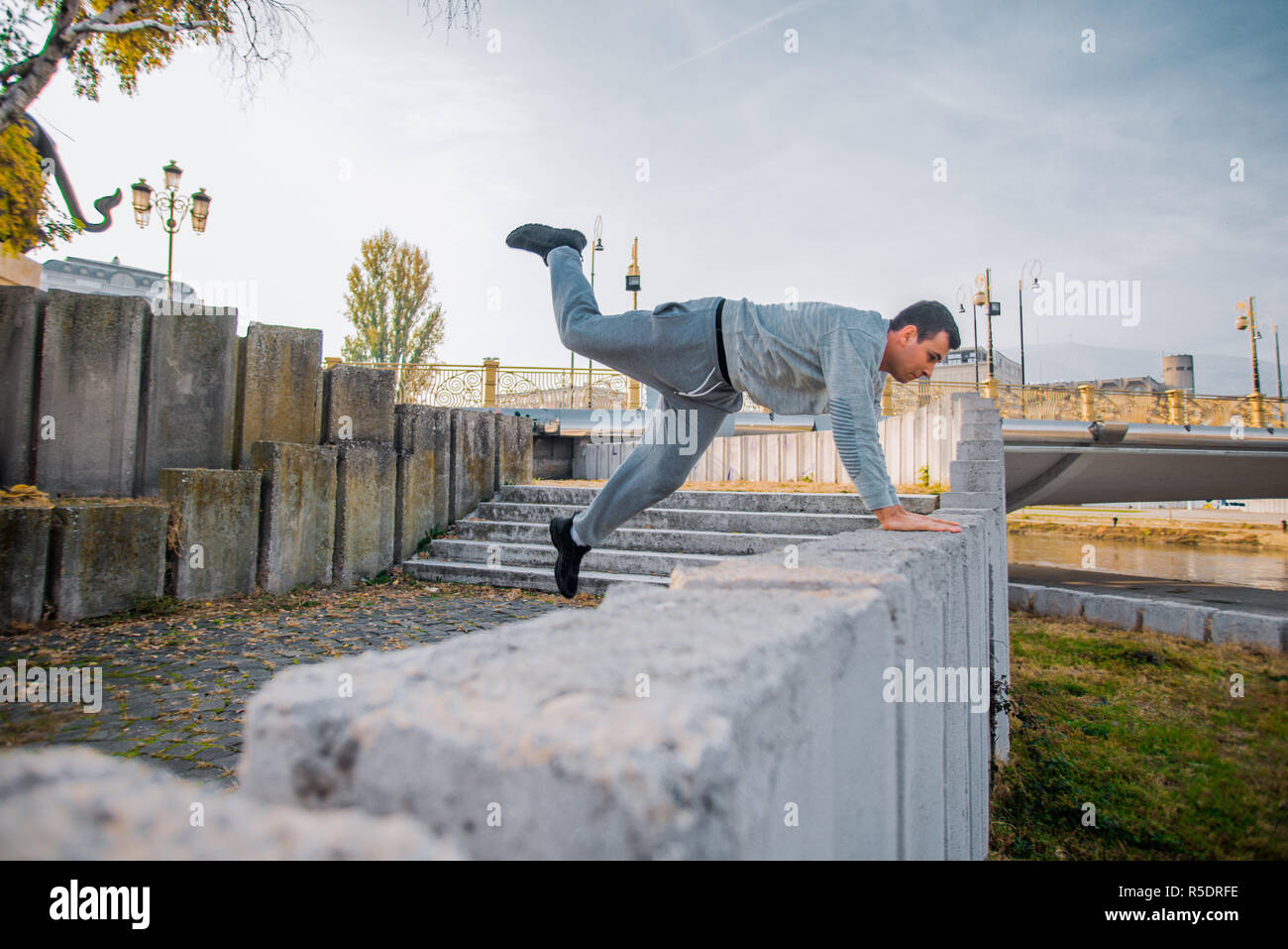 Sportsman jumping over obstacles while exercising Stock Photo - Alamy