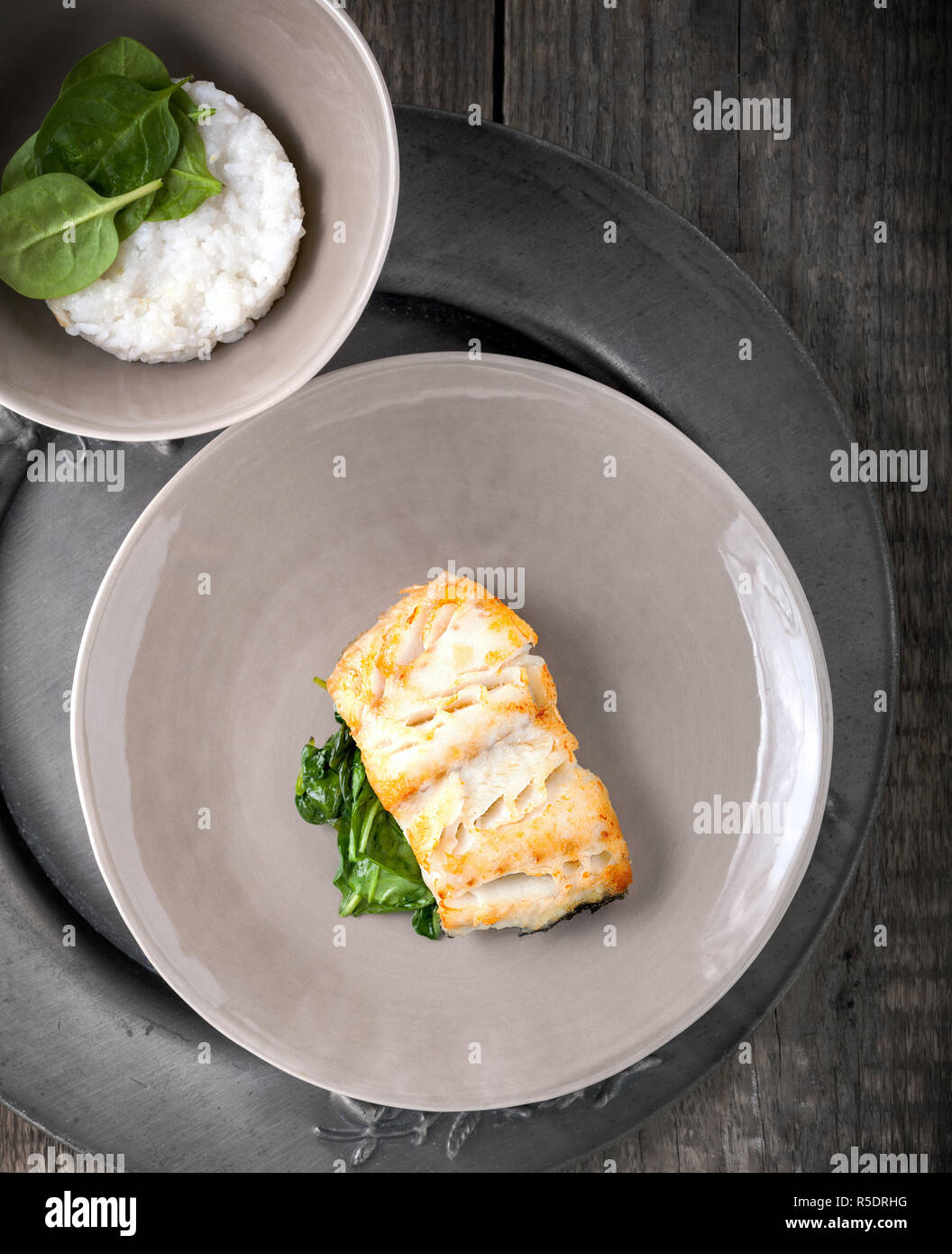 Fried cod fillets and spinach Stock Photo - Alamy