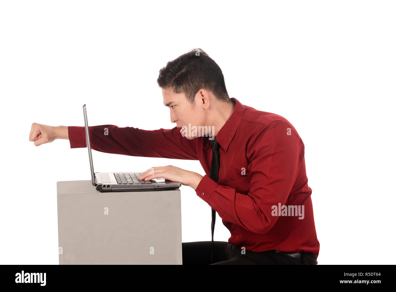 Angry business man punch laptop Stock Photo - Alamy