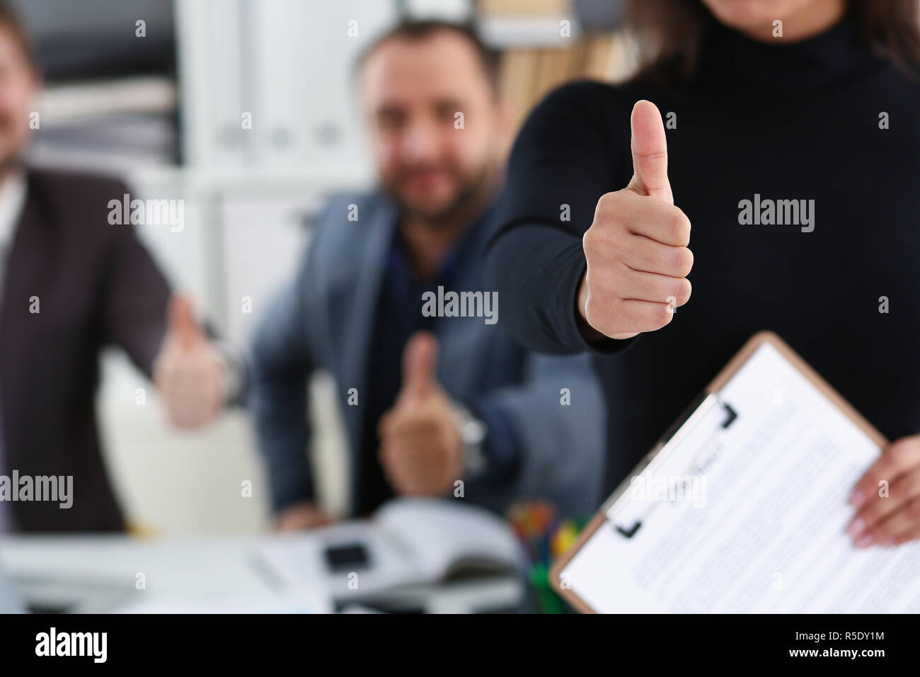 group of young businessmen are happy make good deal show big finger ...