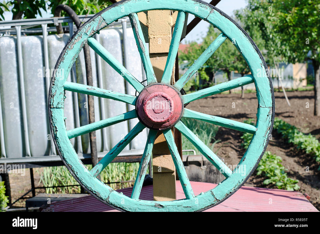 Green wooden cart wheel Stock Photo - Alamy