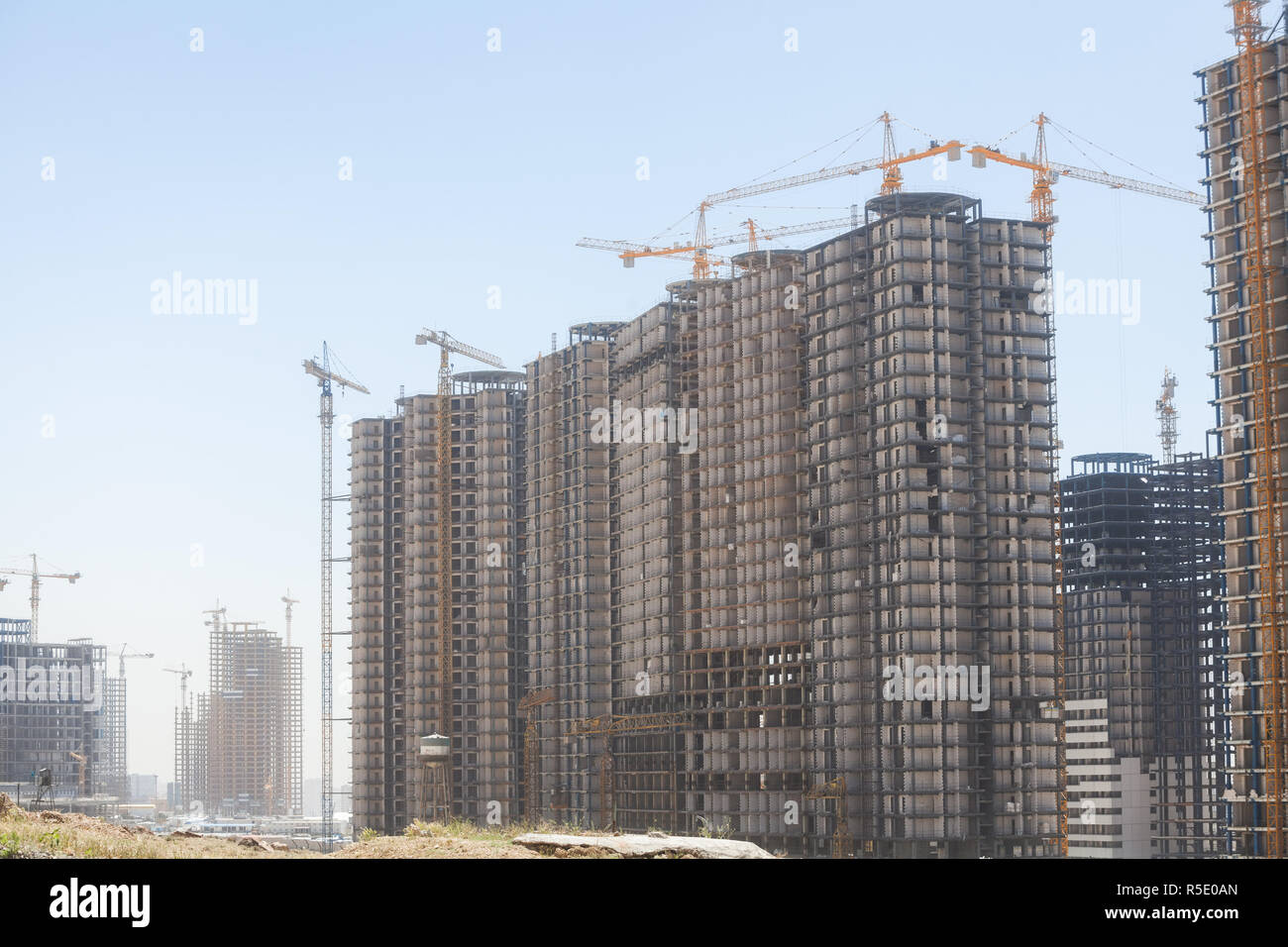 Cranes building a block Stock Photo - Alamy
