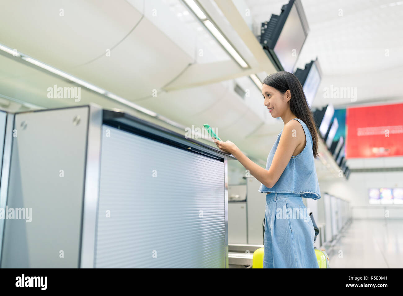 Travel woman in check in counter at airport Stock Photo - Alamy