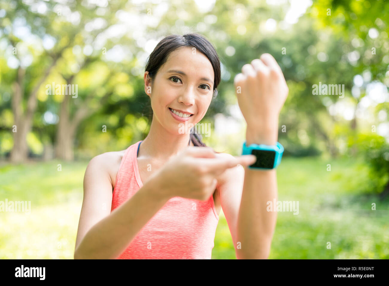 Asian woman checking smartwatch hi-res stock photography and images - Alamy