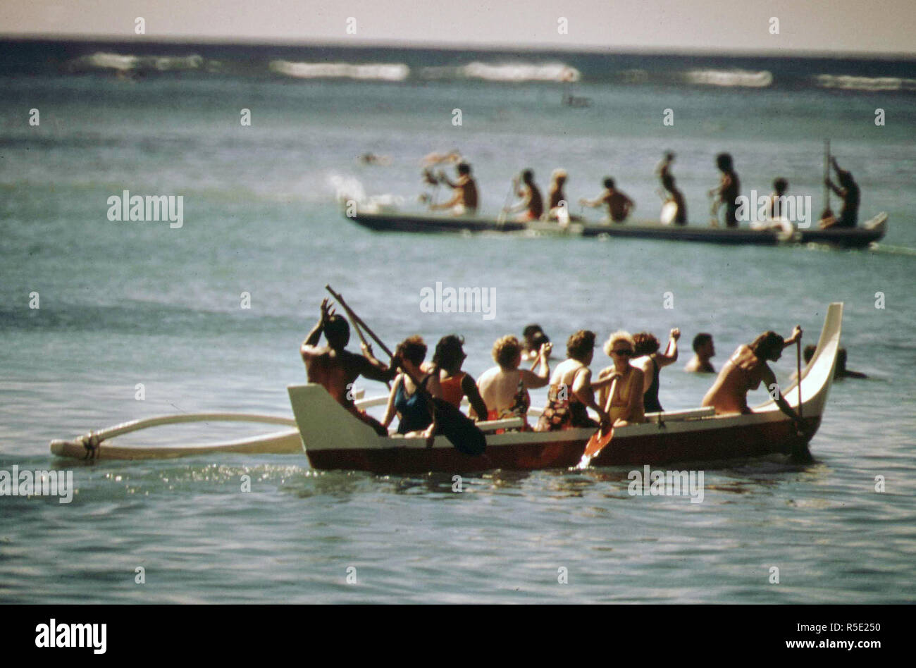Waikiki Beach visitors enjoy the outrigger canoe, October 1973 Stock ...
