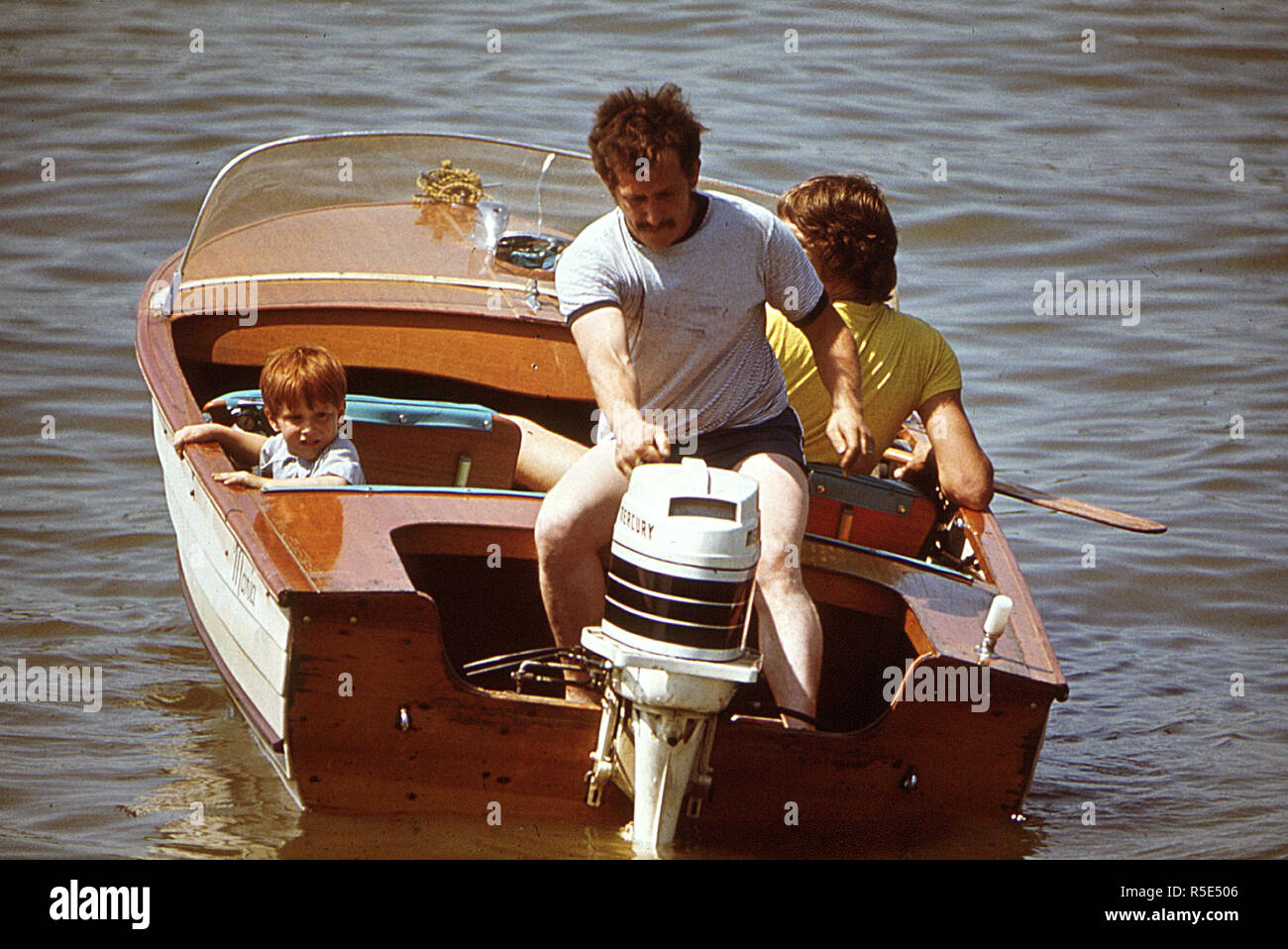 Man starting outboard motor while boating On The Ohio River, June 1972 ...