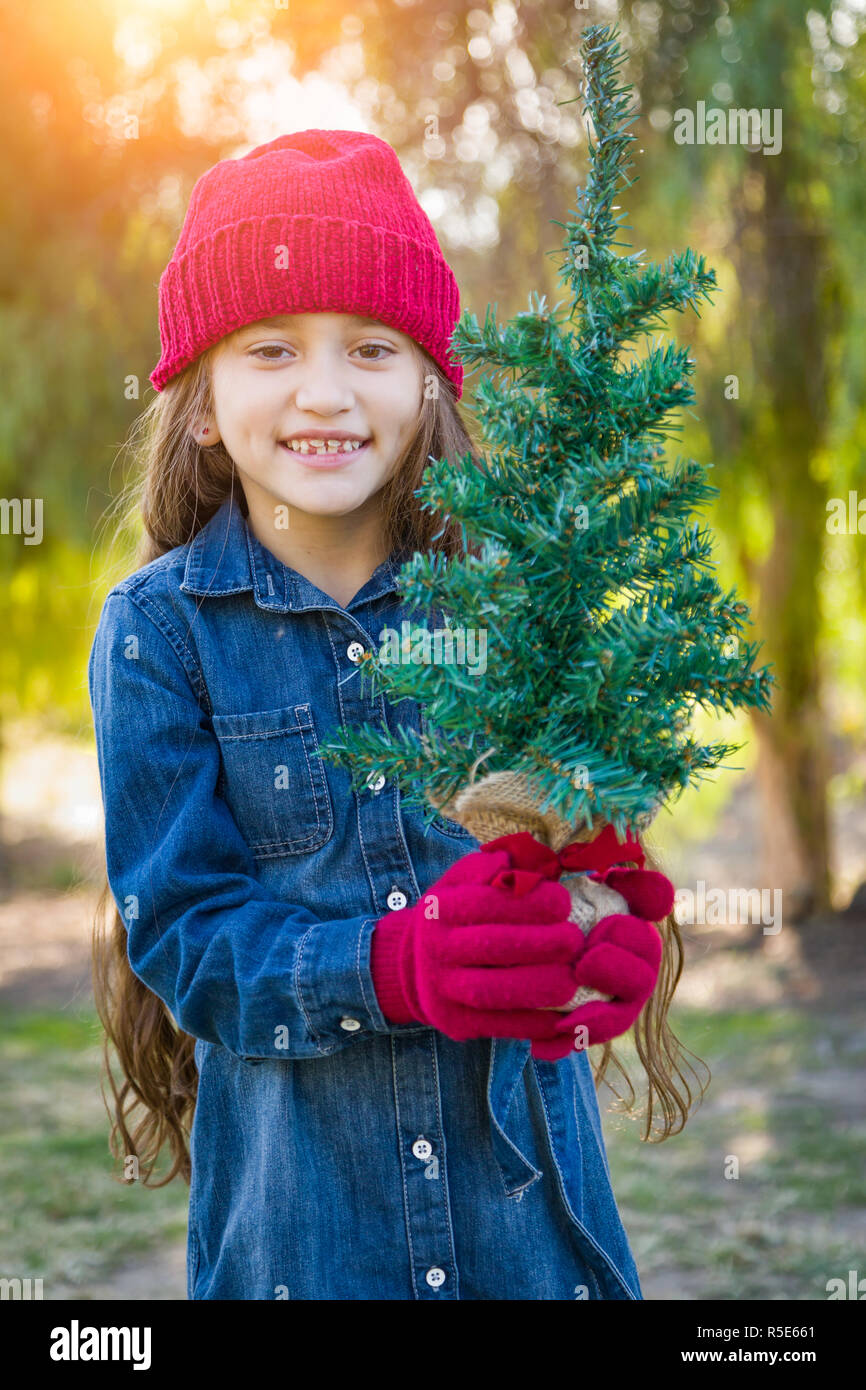 Cute Mixed Race Young Girl Wearing Red Knit Cap and Mittens Holding ...